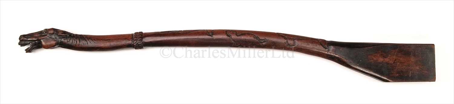 Lot 179 - A CARVED WOODEN TILLER the stock with